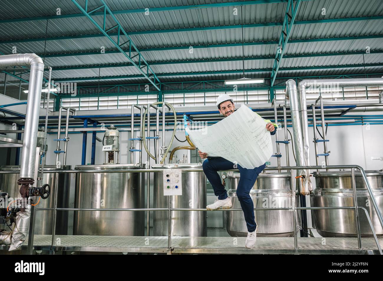 Caucasian technician engineer man in uniform sitting and holding ...