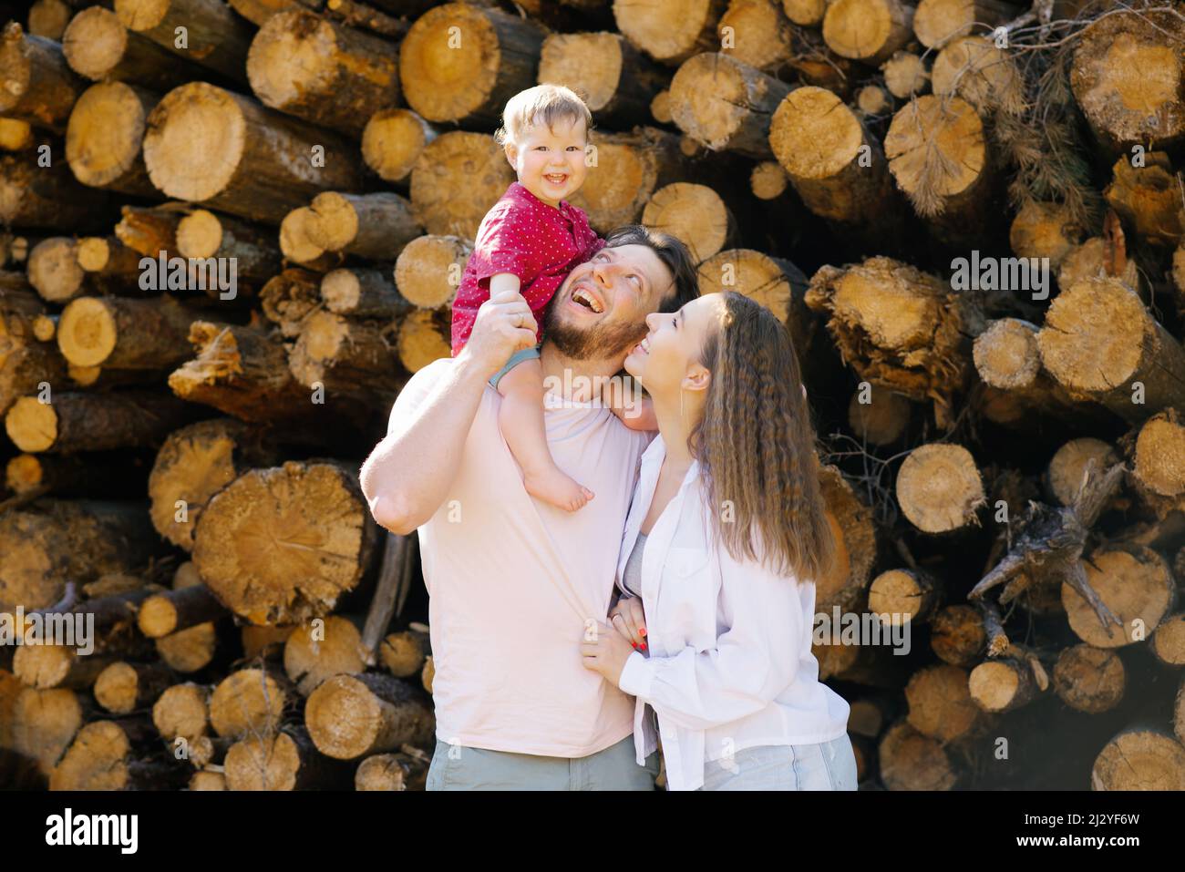 Dad, mom and baby son have fun in the fresh air. A happy family spends ...
