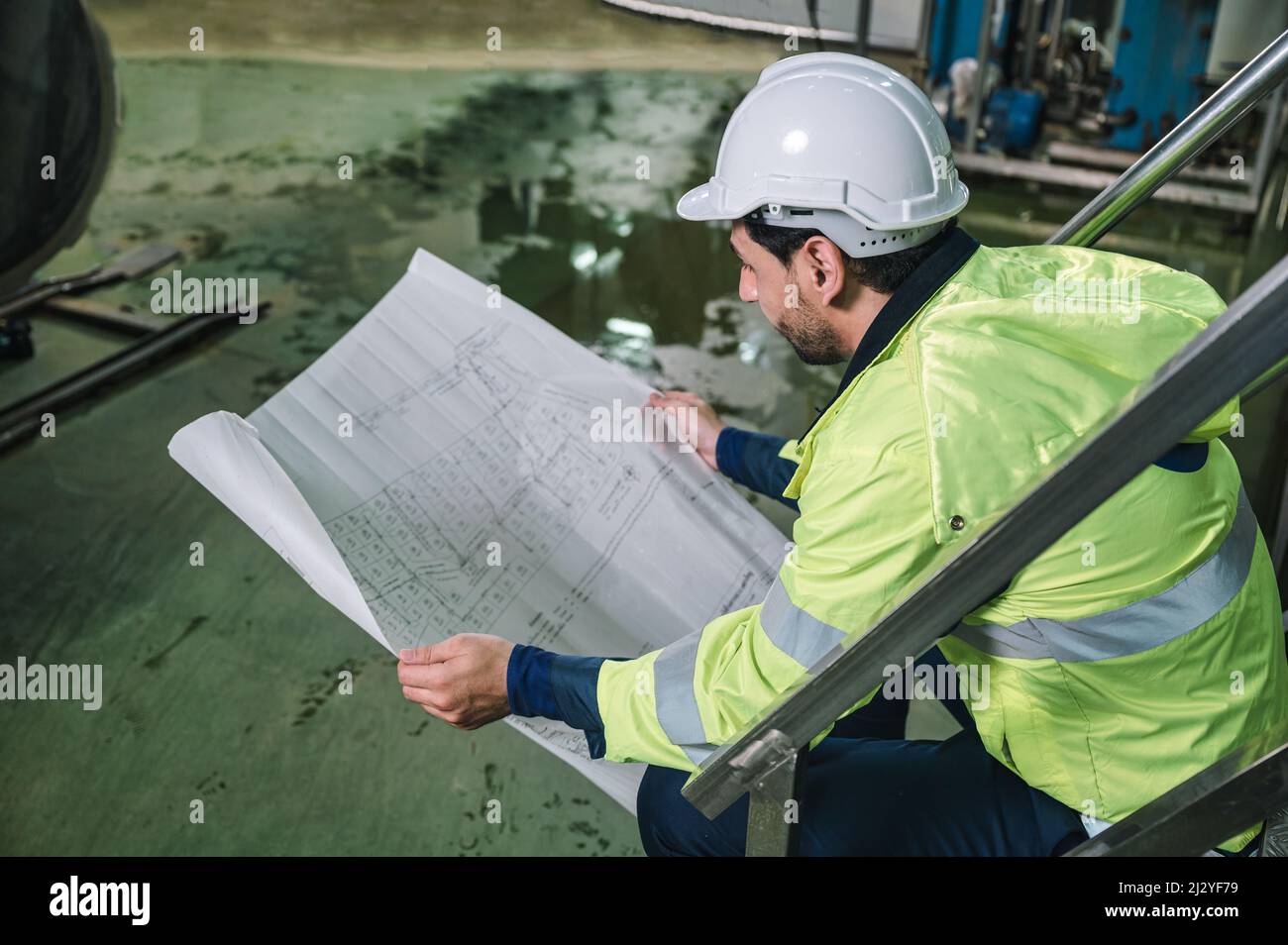 Caucasian technician engineer man in uniform sitting and holding ...