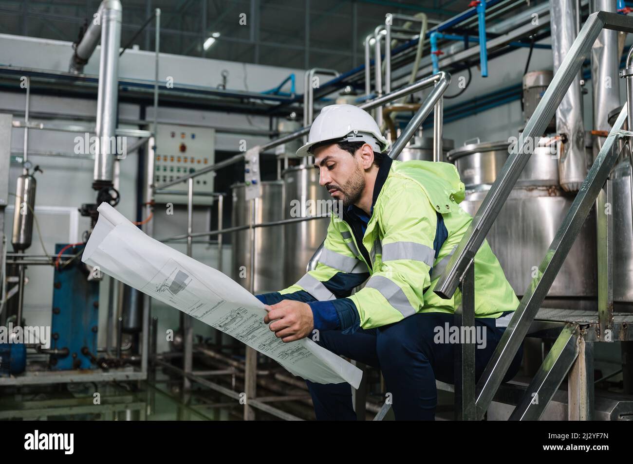 Caucasian technician engineer man in uniform sitting and holding ...