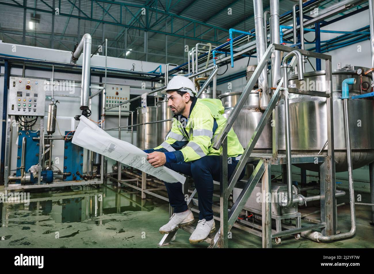 Caucasian technician engineer man in uniform sitting and holding ...
