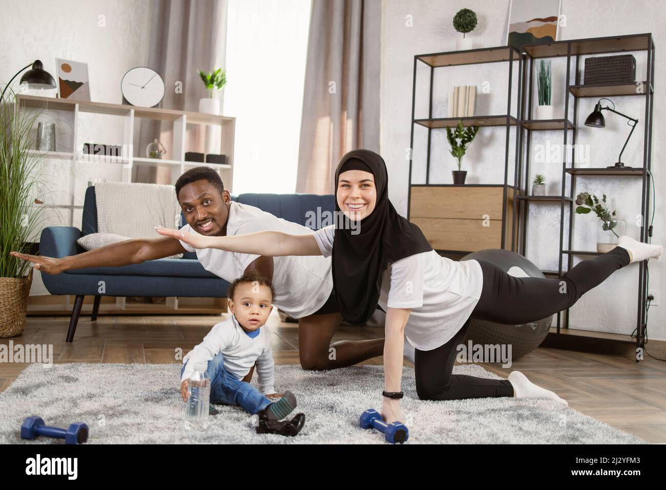 Young attractive family african man and muslim arabic woman practising ...