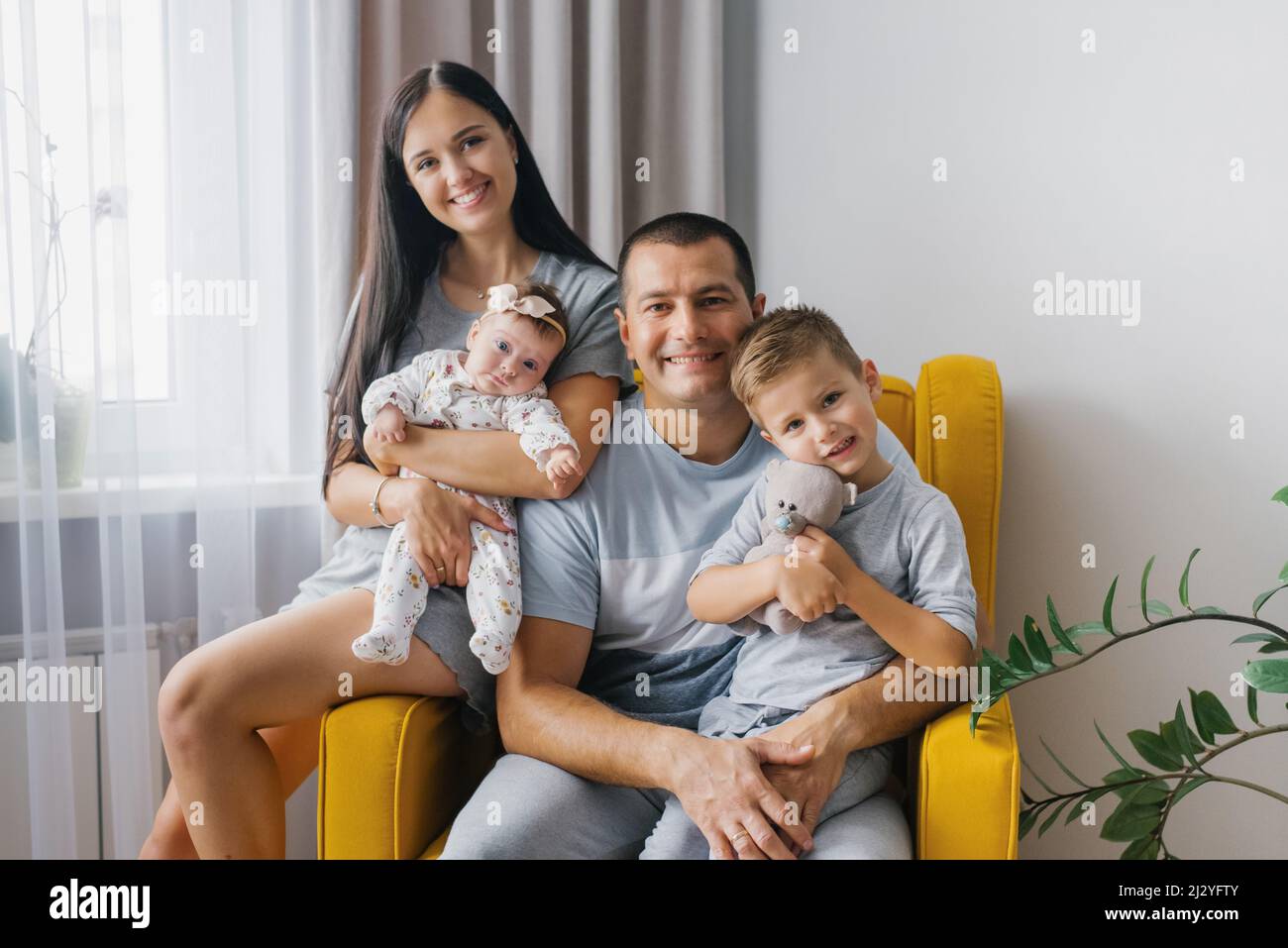 Portrait of a beautiful happy family with two small children in their ...