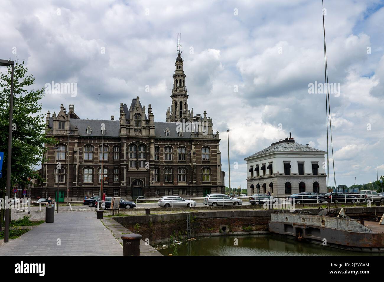 A Loodswezen Historical building facade with a tower and the docks in ...
