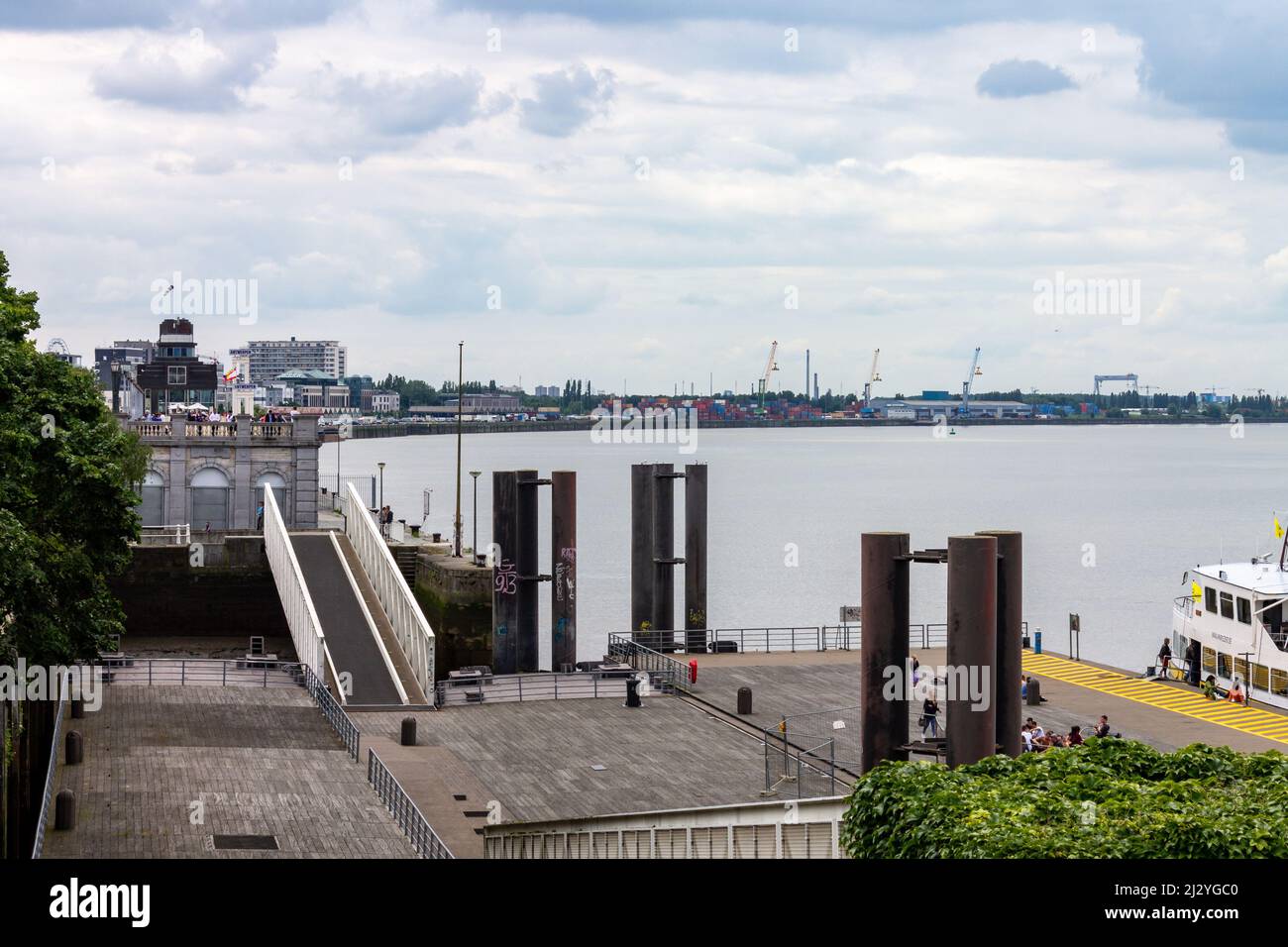 A horizontal shot of a Scheldt river surrounded with buildings in ...