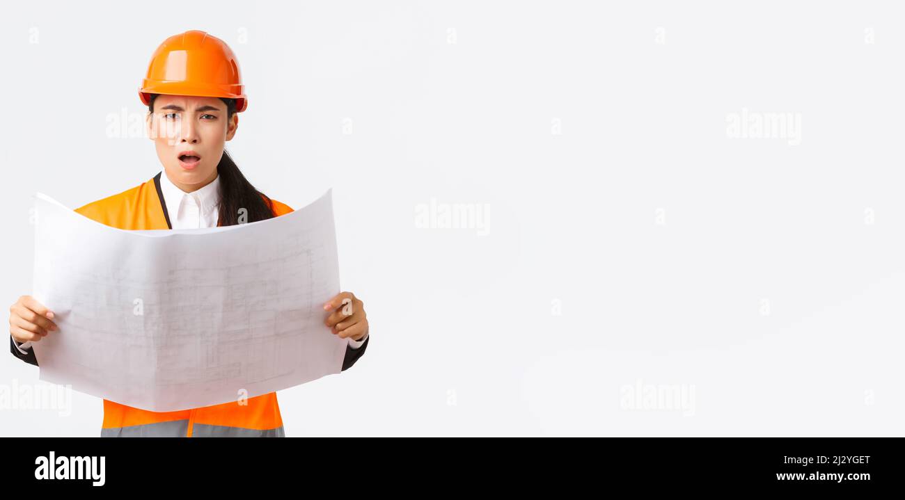 Frustrated and displeased female asian engineer, chief architect at ...