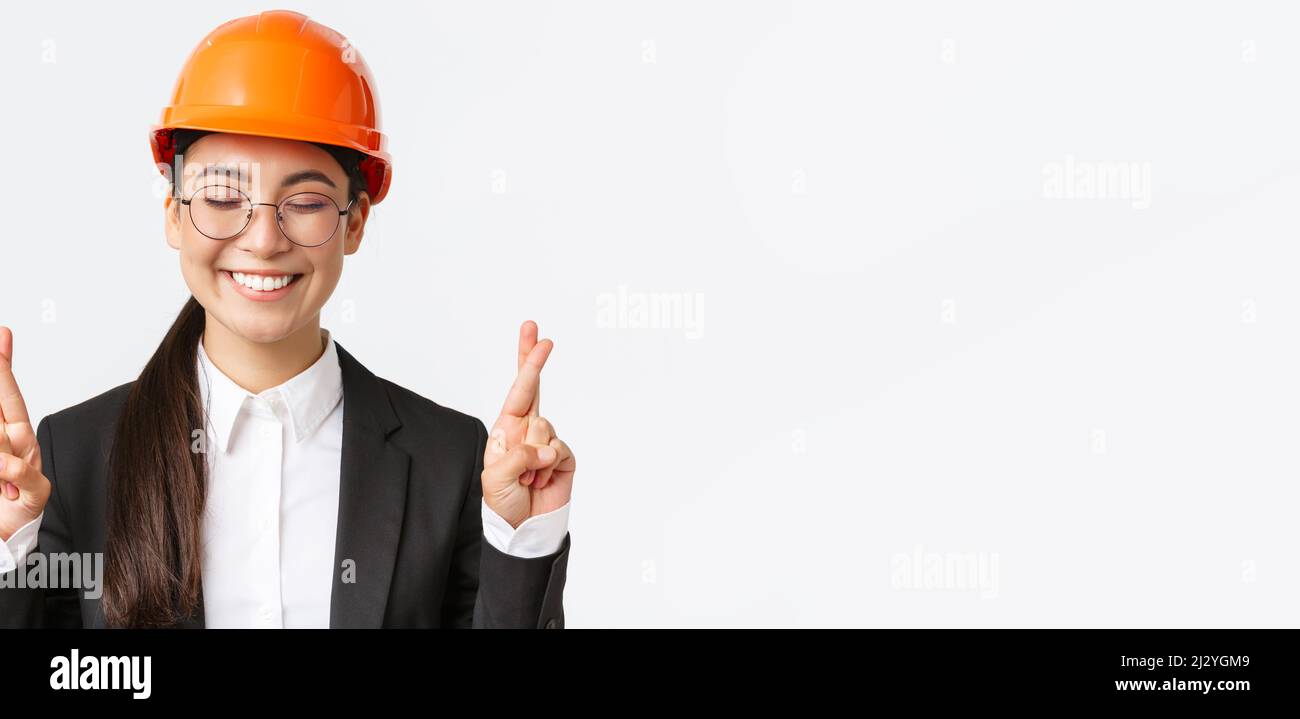 Close-up of hopeful optimistic asian female engineer, architect having ...