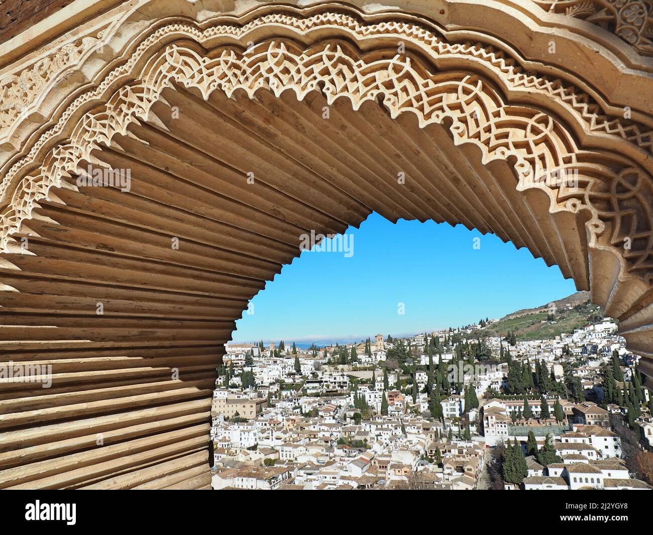 A shot from an arch design of building with old style of a cityscape ...