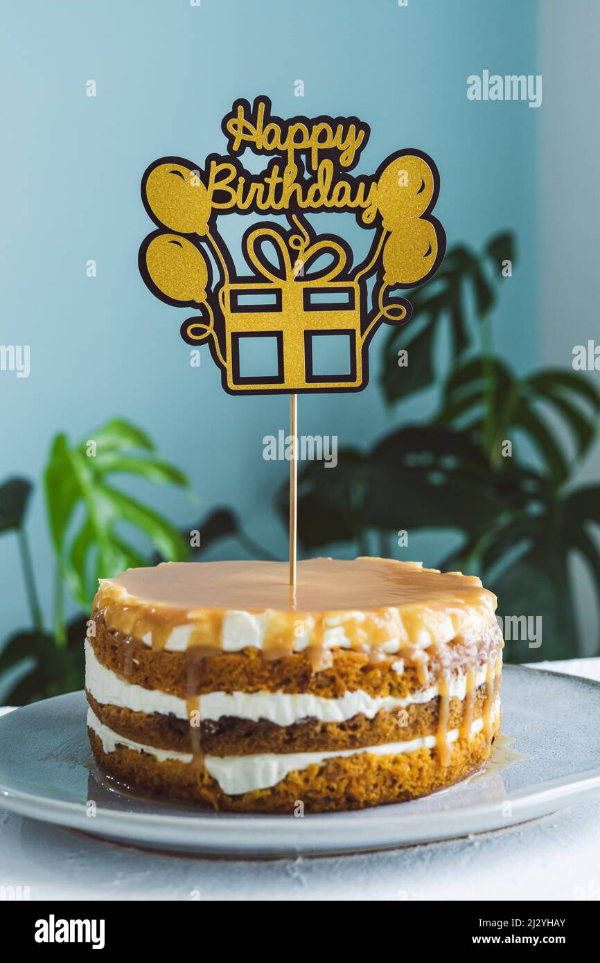 Cake with Birthday topper. Copy space. Blurred background. Vertical ...