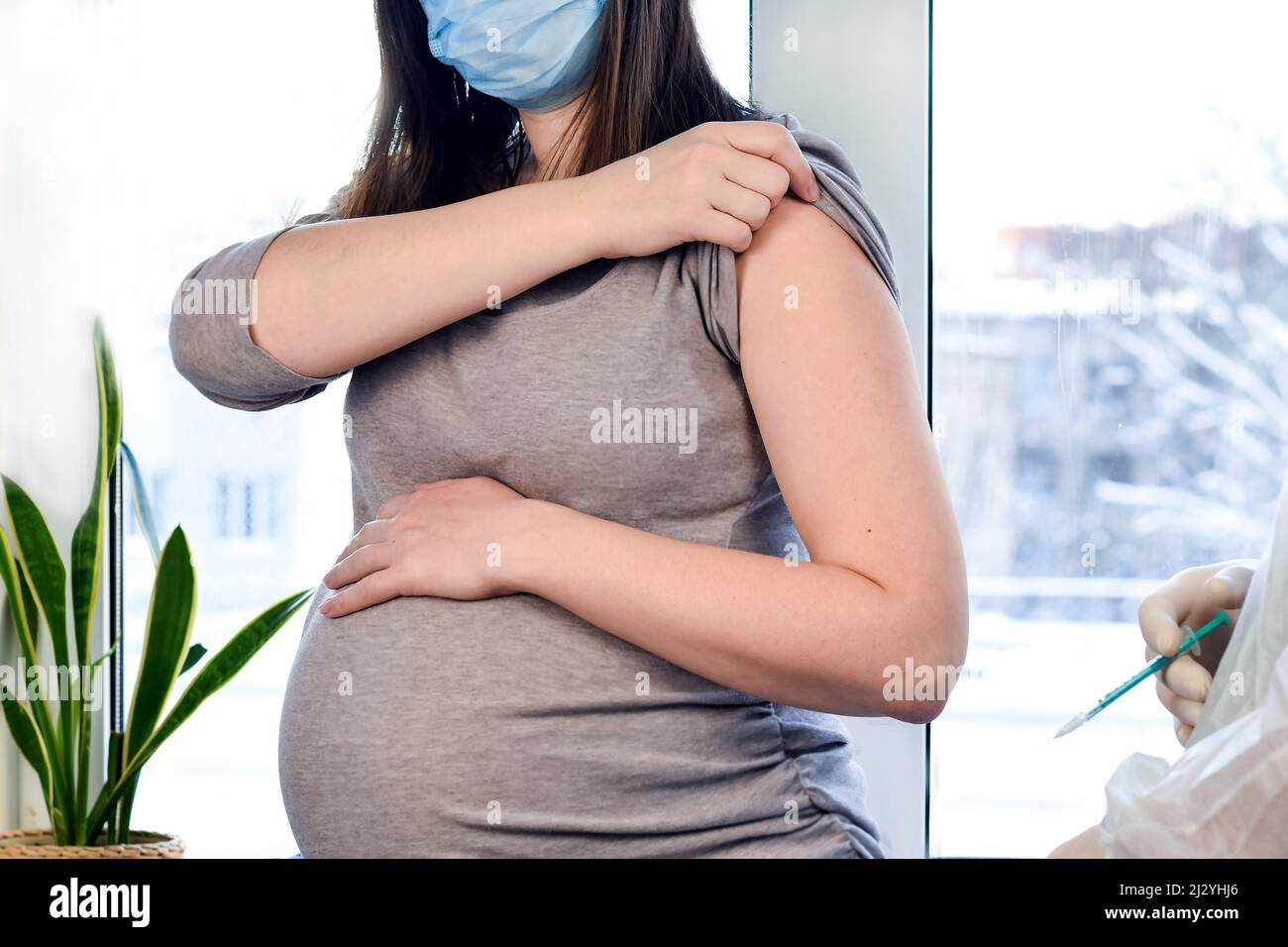 Doctor giving COVID-19 coronavirus vaccine injection to pregnant woman ...
