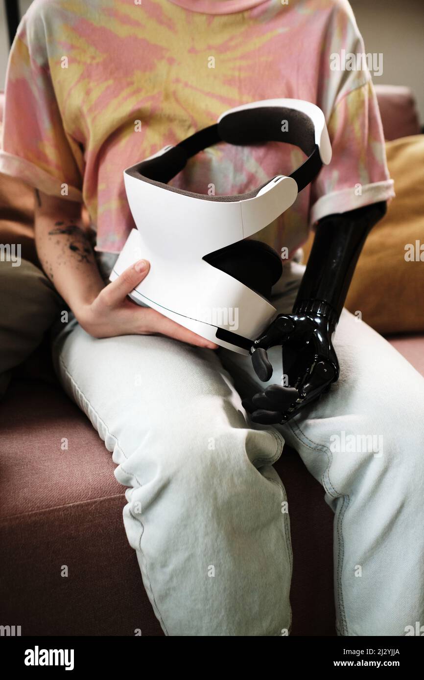 Close-up of girl with prosthetic arm using virtual reality simulator ...