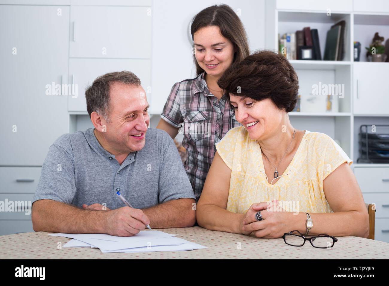 Cheerful senior man and woman signing documents Stock Photo - Alamy