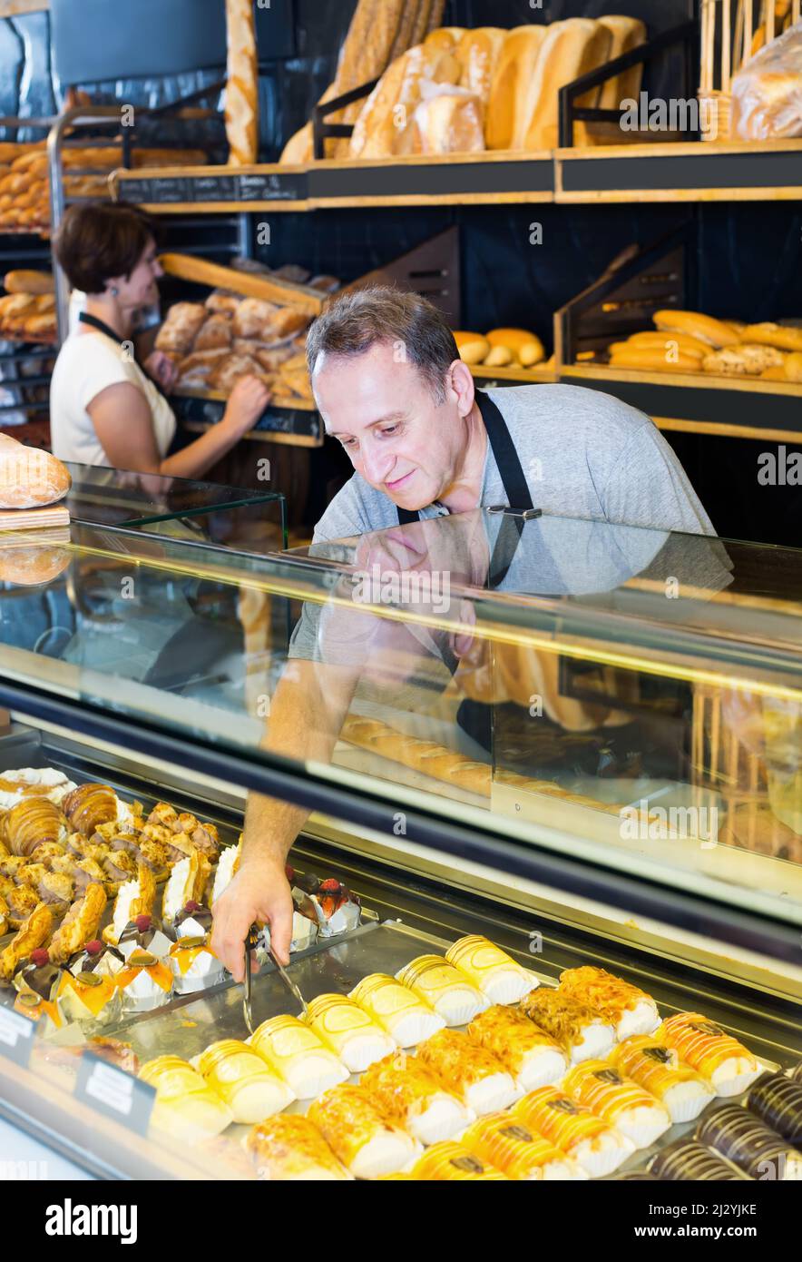 Employee working with sweet confectionery products Stock Photo - Alamy
