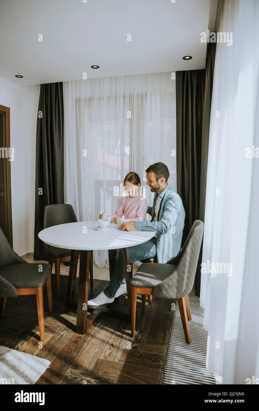 Father and daughter drinking tea together at the living room Stock ...