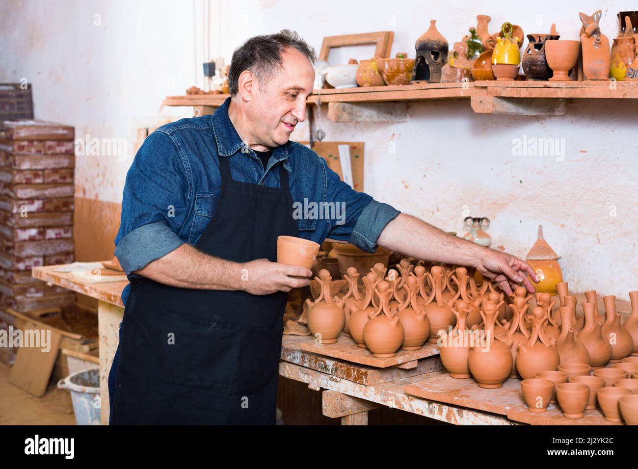 Happy potter at the workshop Stock Photo - Alamy