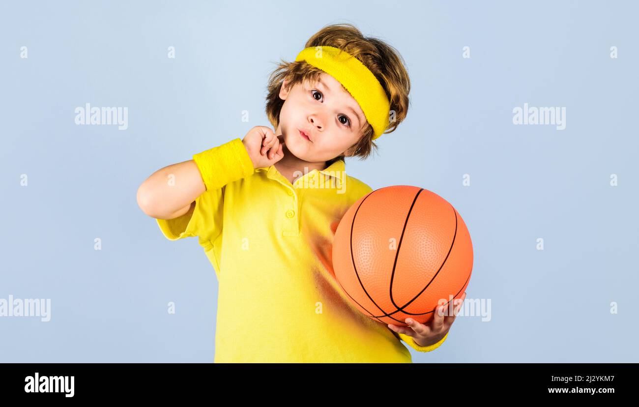 Little basketball player in sportswear with ball. Children and sport ...