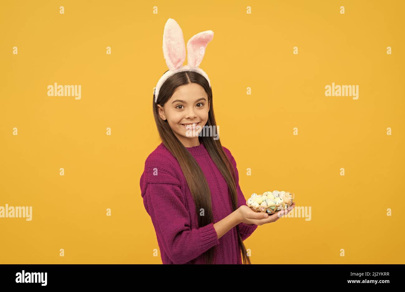 happy easter teen girl in funny bunny ears hold painted quail eggs ...