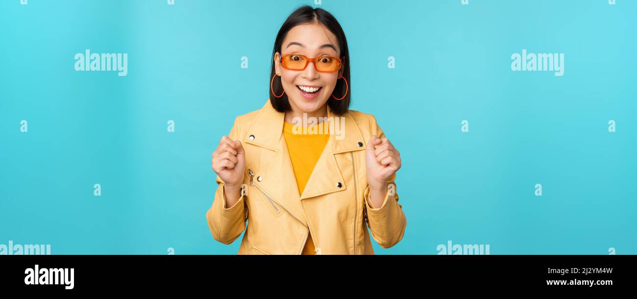 Image of enthusiastic young asian woman celebrating, triumphing ...