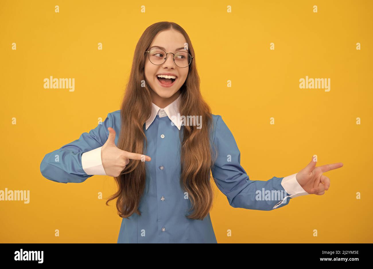 Happy back to school child point fingers for advertising yellow ...
