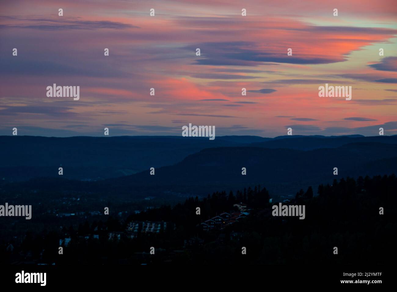 A beautiful view of a colorful sunset over hills Stock Photo - Alamy