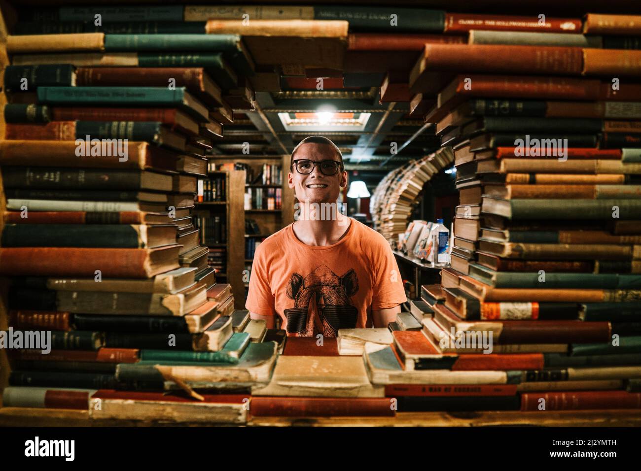 A beautiful caucasian male posing for a photo in the library Stock ...