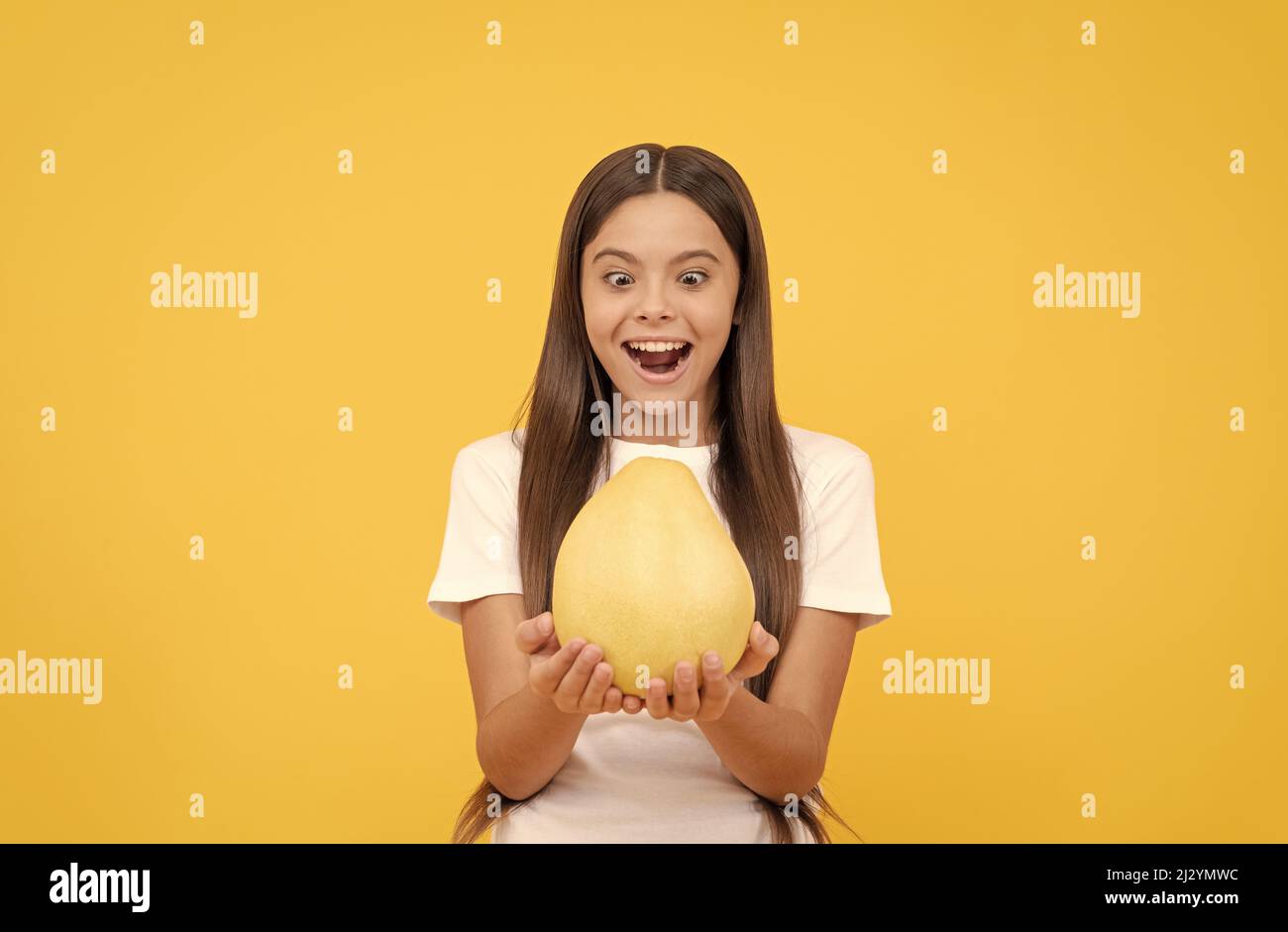 happy child girl hold big citrus fruit of yellow pummelo or pomelo full ...
