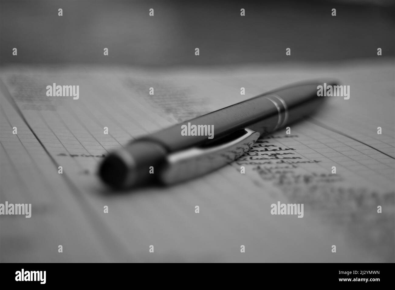 Pen laying on paper Stock Photo - Alamy