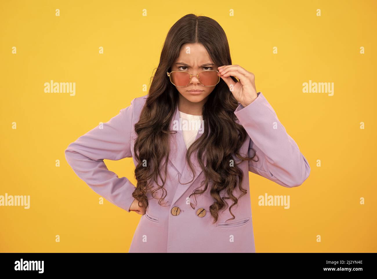 keep under control. serious kid with curly hair in sunglasses. beauty ...