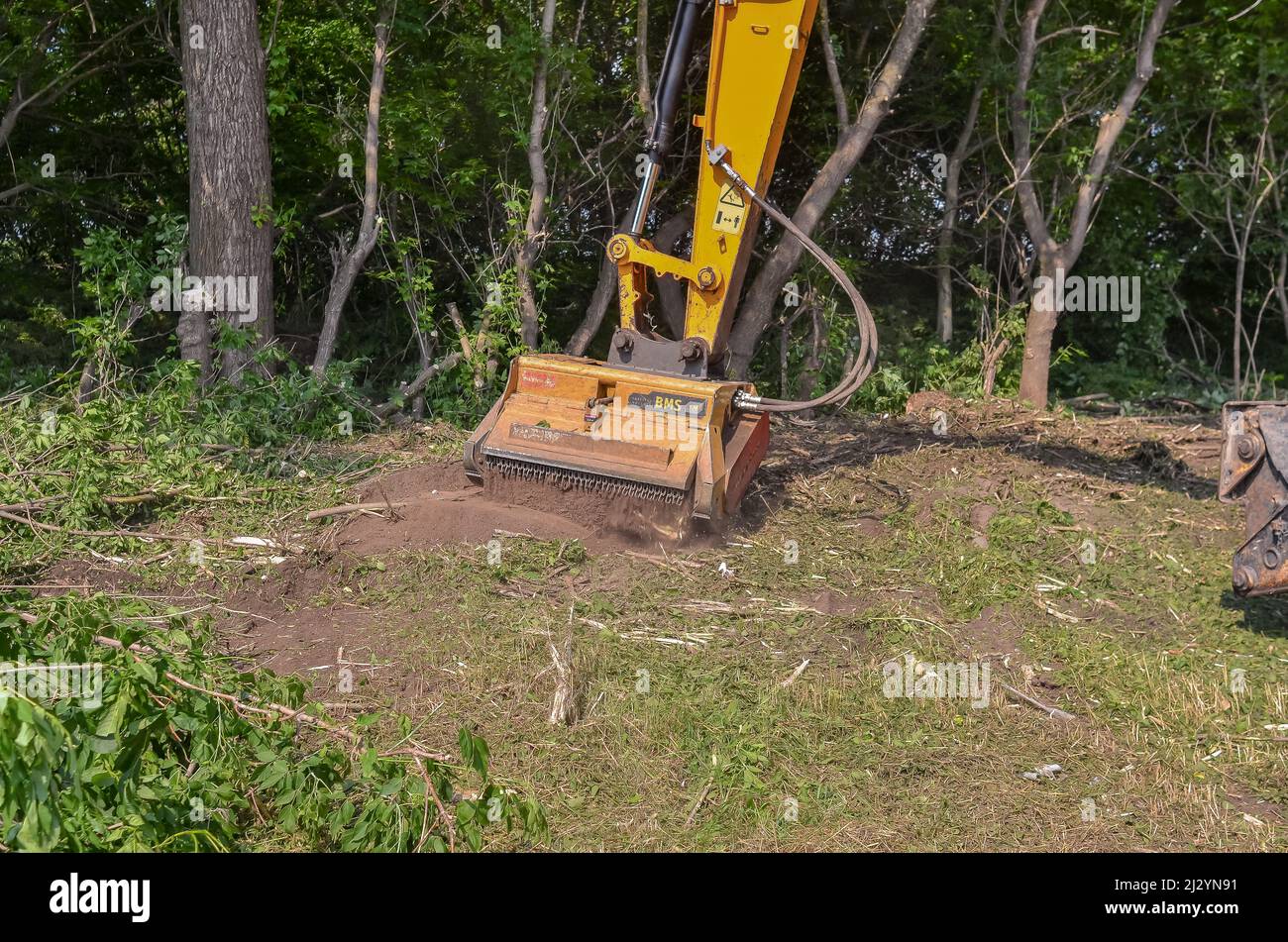 Mulcher clears roadside of vegetation. Road works Stock Photo - Alamy