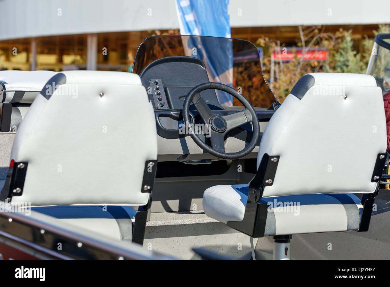 The steering wheel on the captain's bridge between the white leather ...