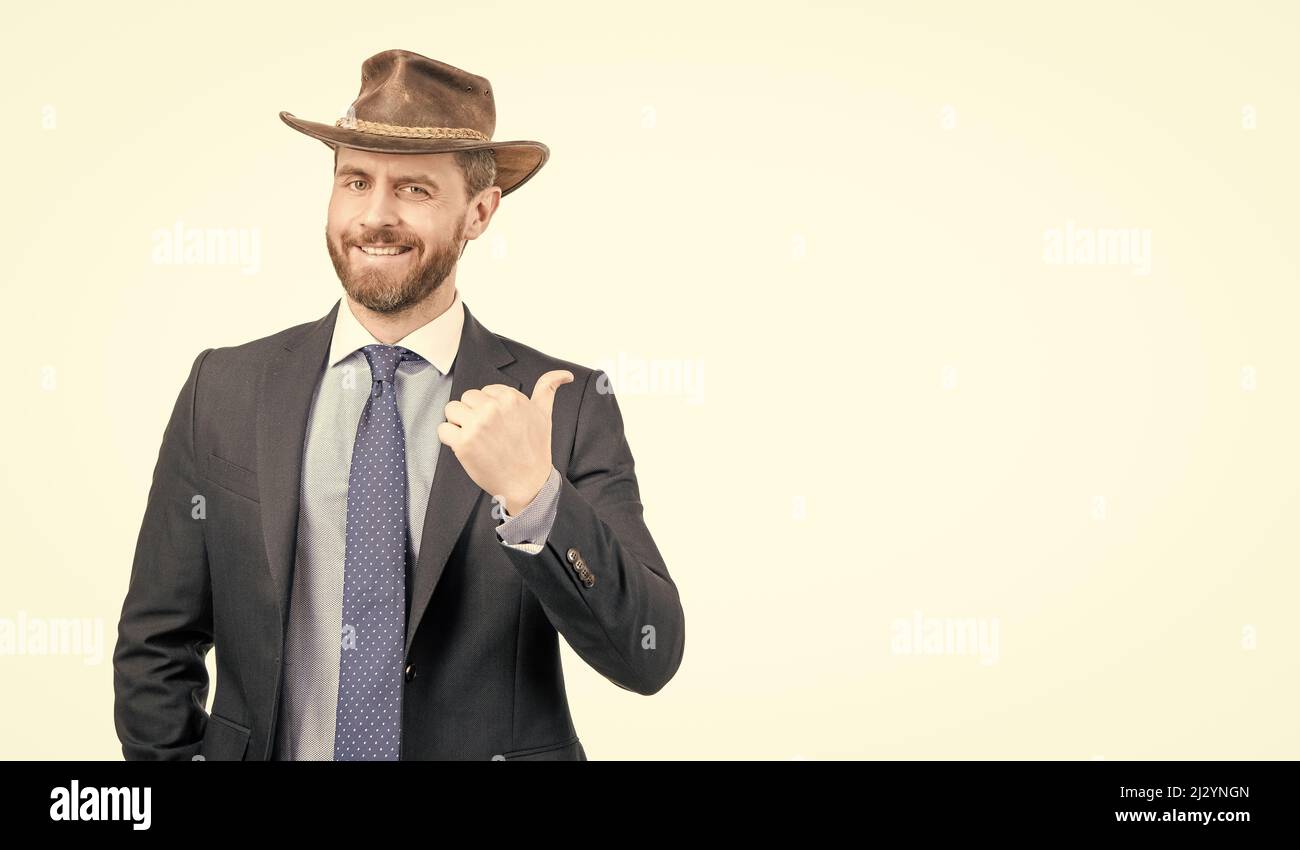 Happy businessman man in cowboy hat and suit smile pointing finger ...