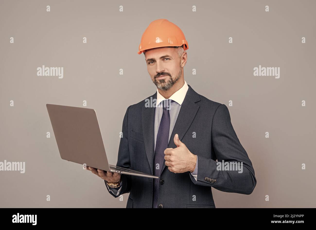 thumb up. agile business success. entrepreneur in helmet use pc ...