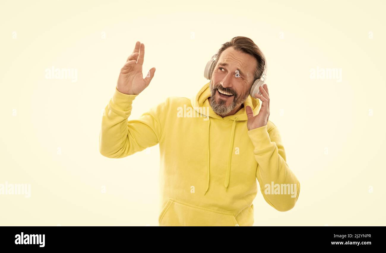 relaxing. singing senior guy listen to music and sing isolated on white ...