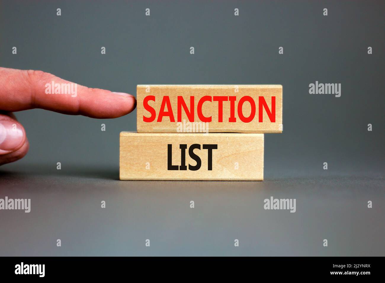 Sanction list symbol. Wooden blocks with concept words Sanction list on ...