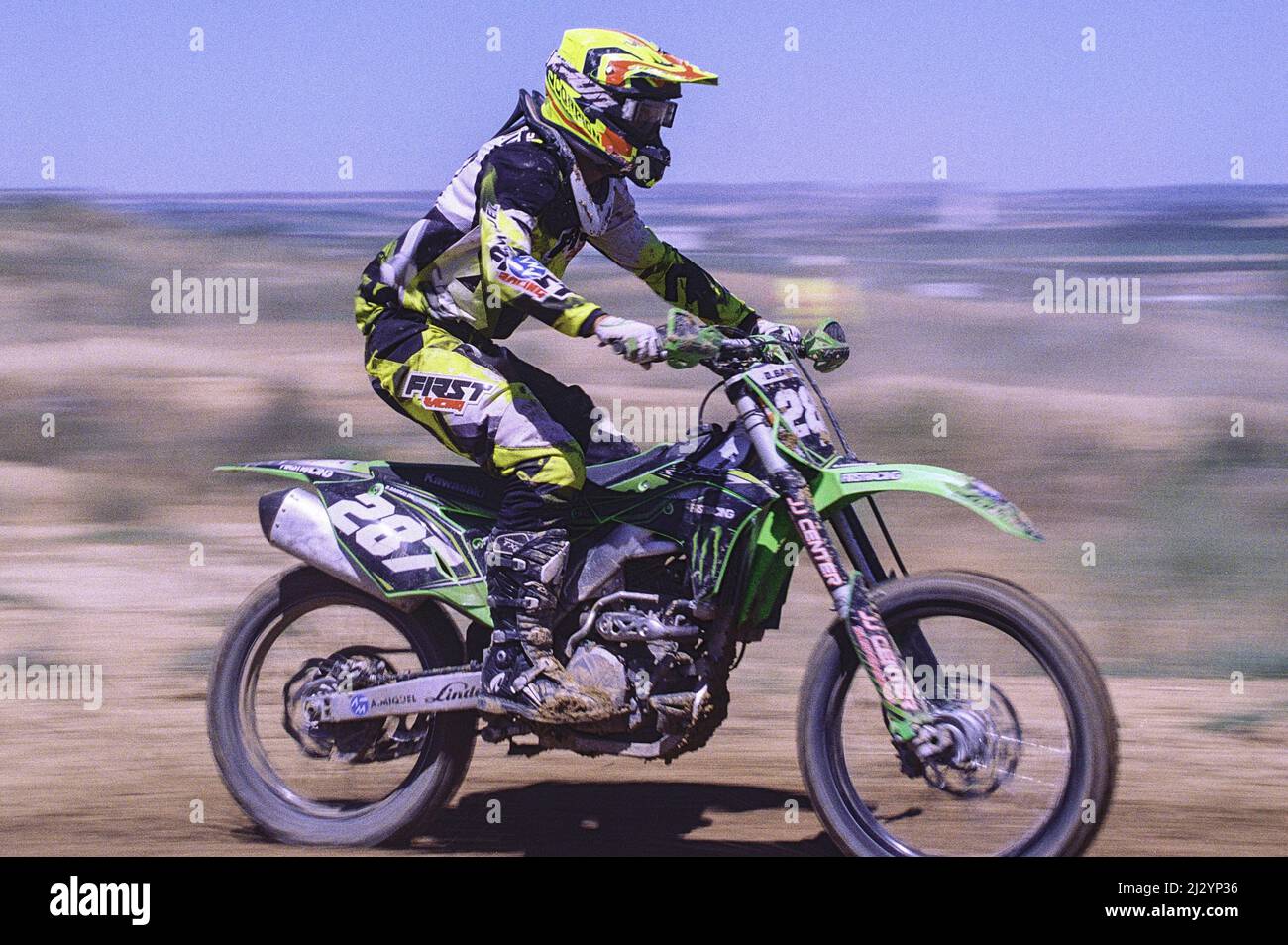 A closeup of a racing sport motocross bike running in the mud track ...