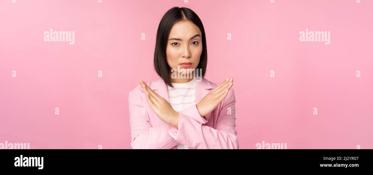 Image of serious corporate woman, asian businesswoman showing stop ...