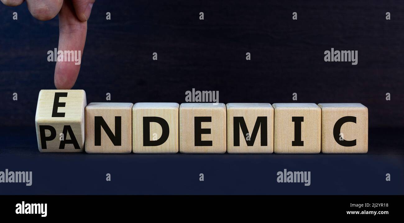 Covid-19 pandemic or endemic symbol. Turned wooden cubes and changed ...