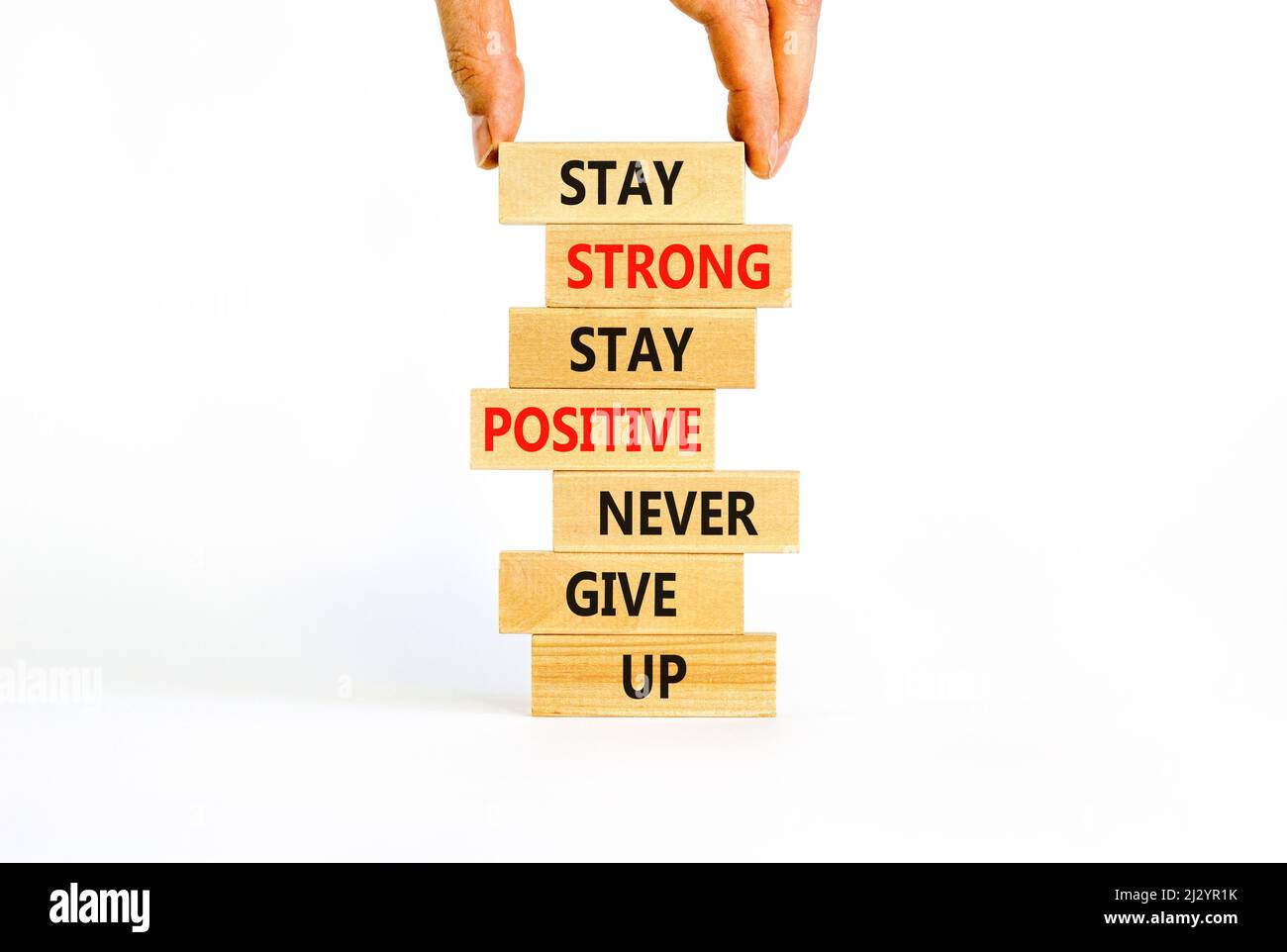Never give up symbol. Wooden blocks with concept words Stay strong stay ...