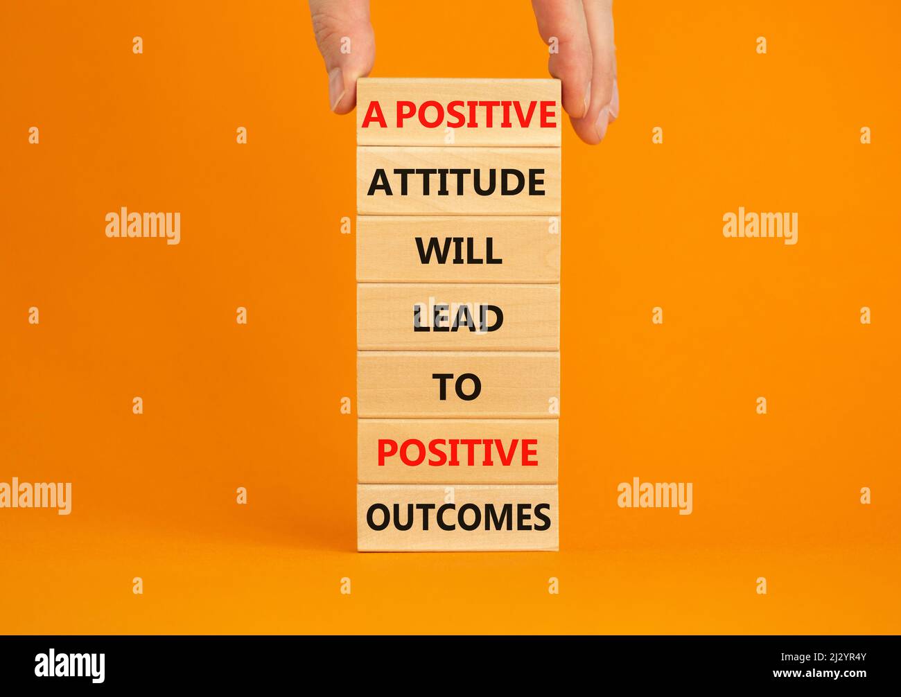 Think positive symbol. Wood blocks with words A positive attitude will ...