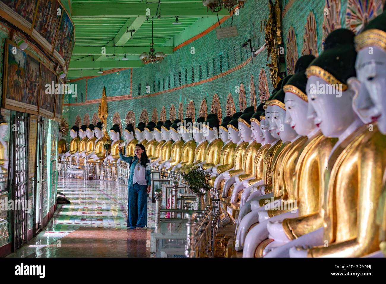 A woman takes a selfie at U Min Thonze Pagoda on Sagaing Hill in ...
