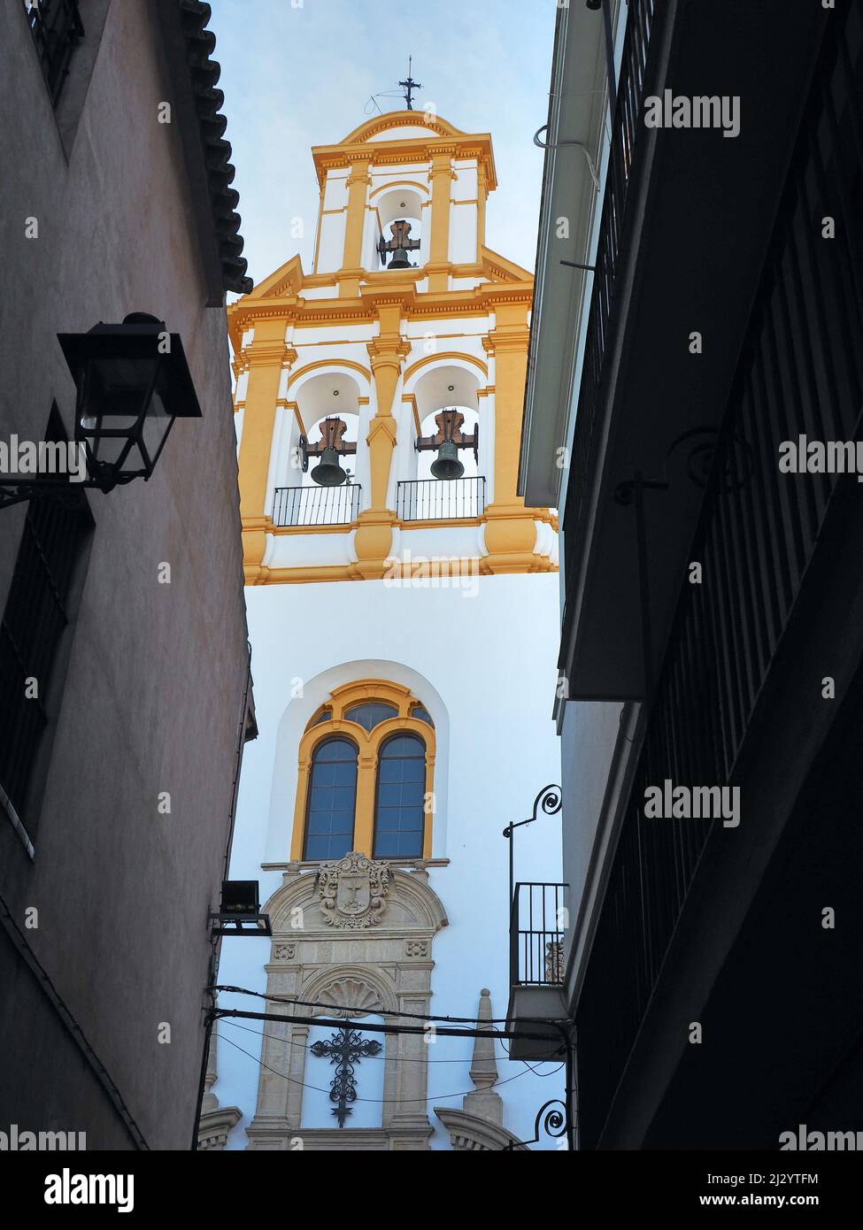 A low angle shot of the exterior design of a white and brown church ...