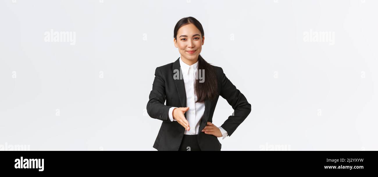 Confident successful businesswoman in black suit extend hand for ...