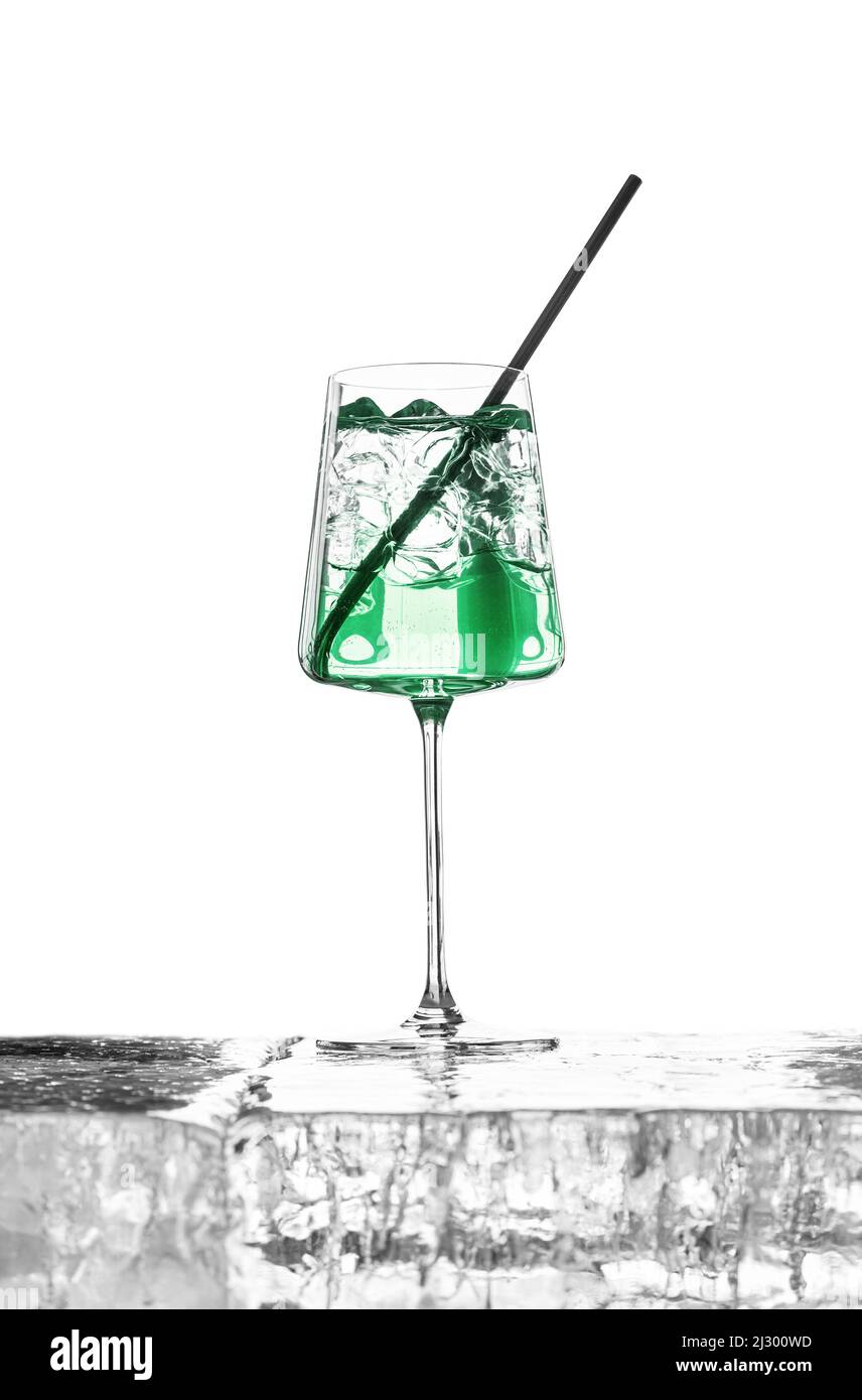 Modern green transparent cocktail standing on ice bar. Isolated white ...