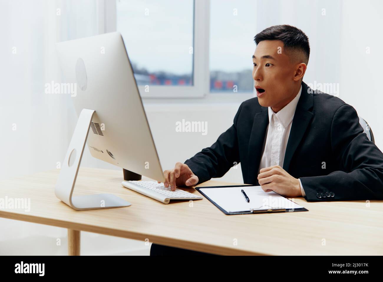Asian man works at the computer emotion office Lifestyle Stock Photo ...