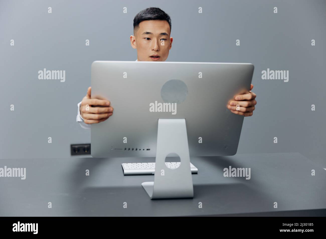 worker holding on to the monitor emotions office Gray background Stock ...