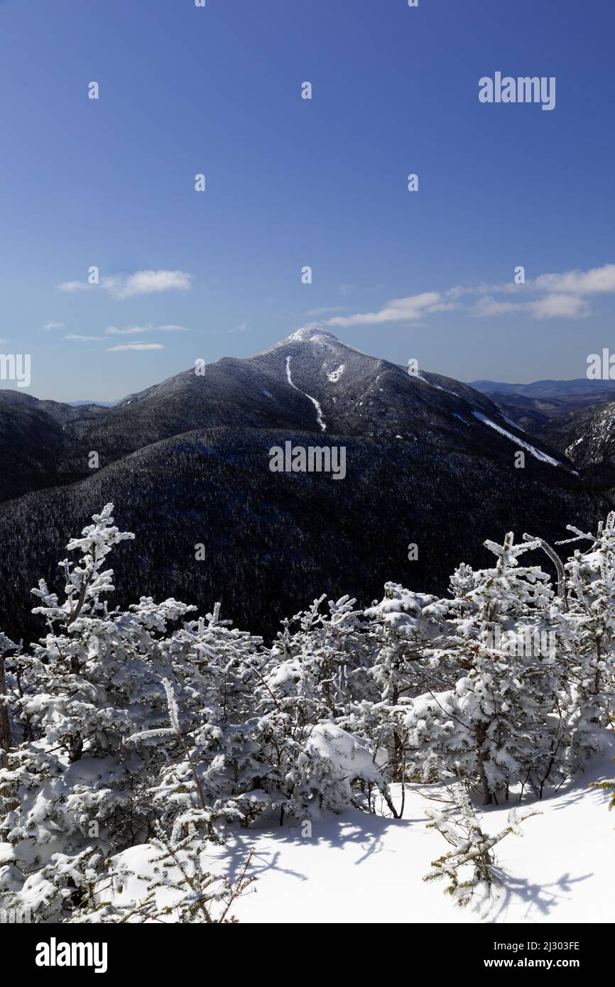A vertical breathtaking view of a snowcap mountain on blue sky ...