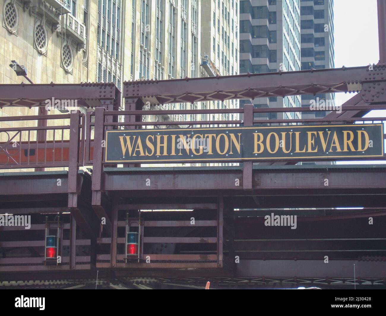 The "Washington Boulevard" sign on the dark red Dearborn Street bridge ...