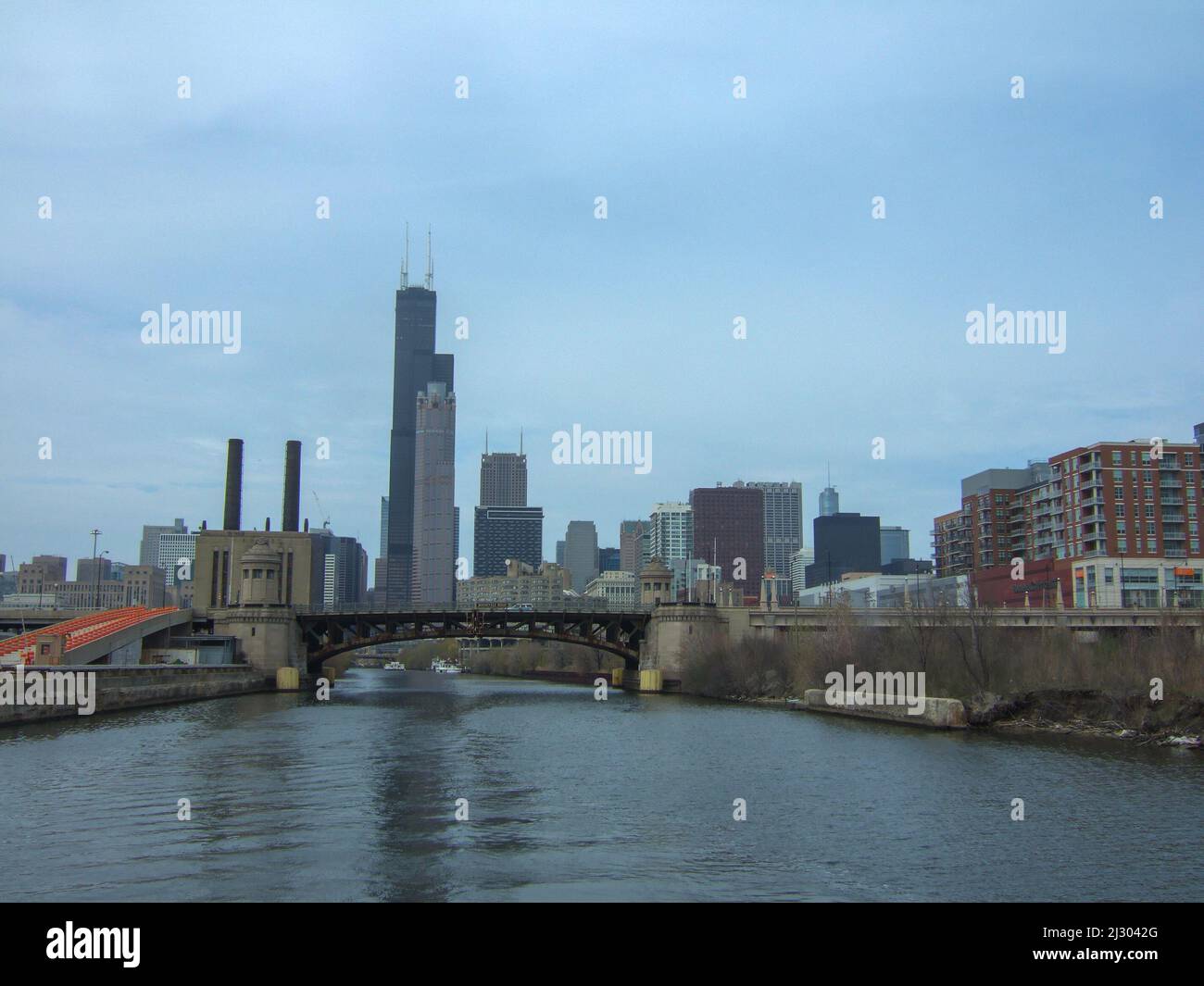 Chicago skyline from Chicago River waterfront under slightly cloudy ...