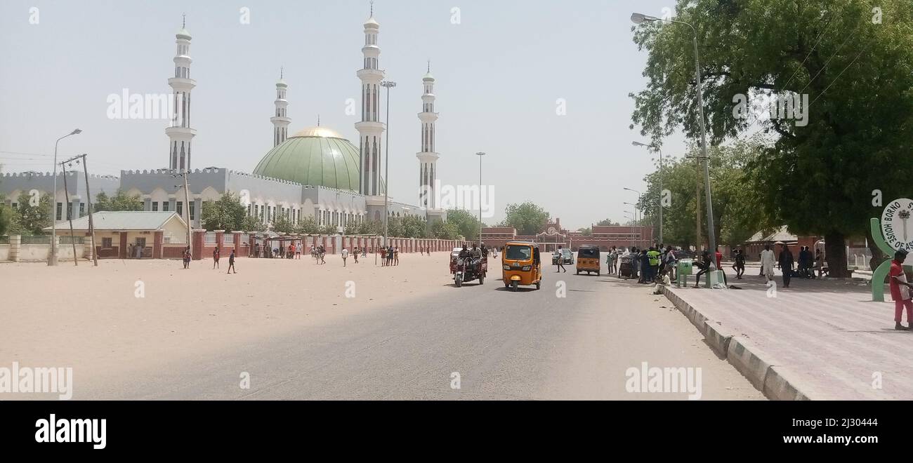 A wide shot of a large street in the daytime in Maiduguri, Nigeria ...
