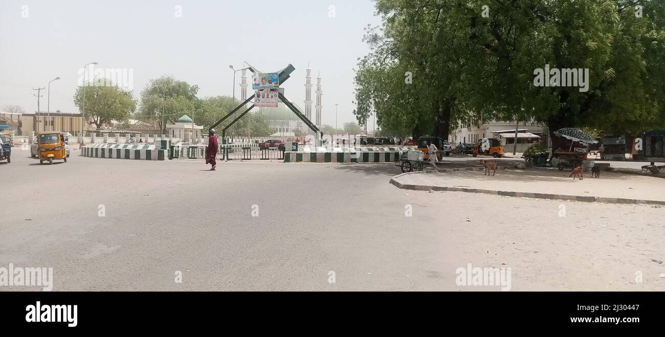 A wide shot of a large street in the daytime in Maiduguri, Nigeria ...